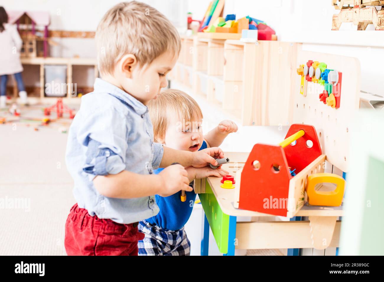 Boys play with wooden toys Stock Photo - Alamy
