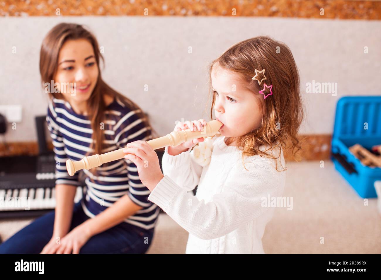 The little girl to play on the flute Stock Photo - Alamy
