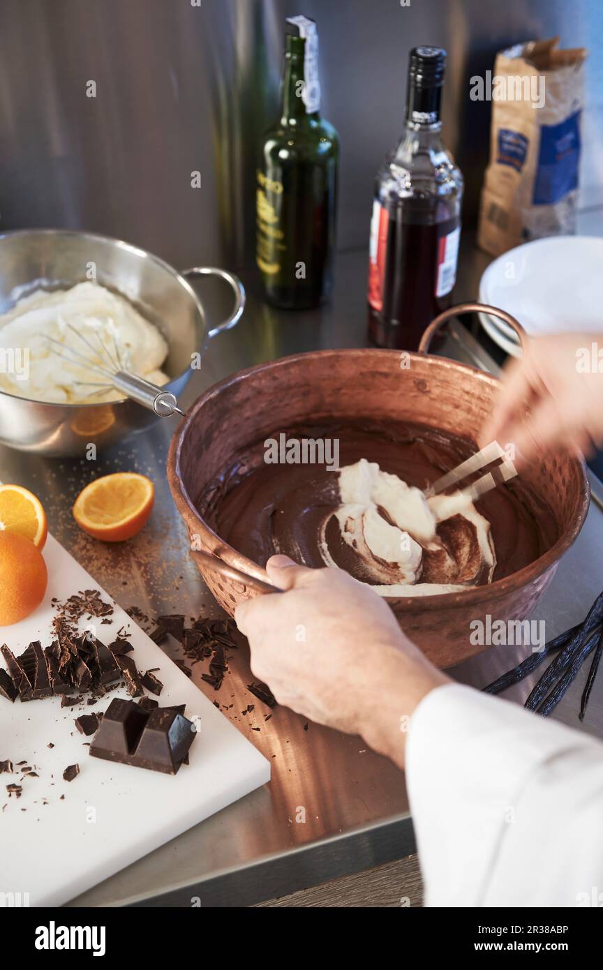 Gradually mixing whipped cream and melted chocolate Stock Photo - Alamy