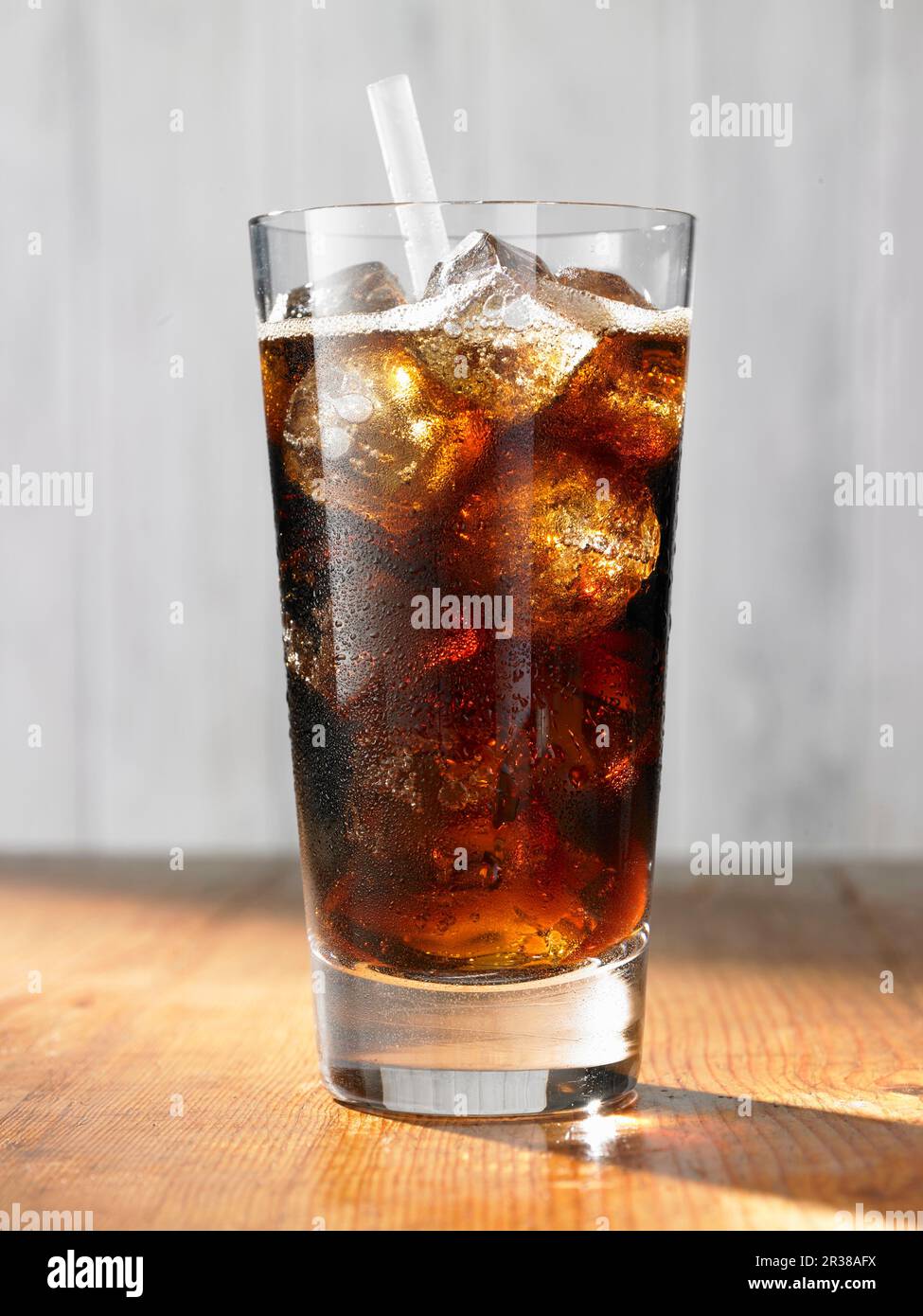 Cola with ice cubes in a glass Stock Photo - Alamy