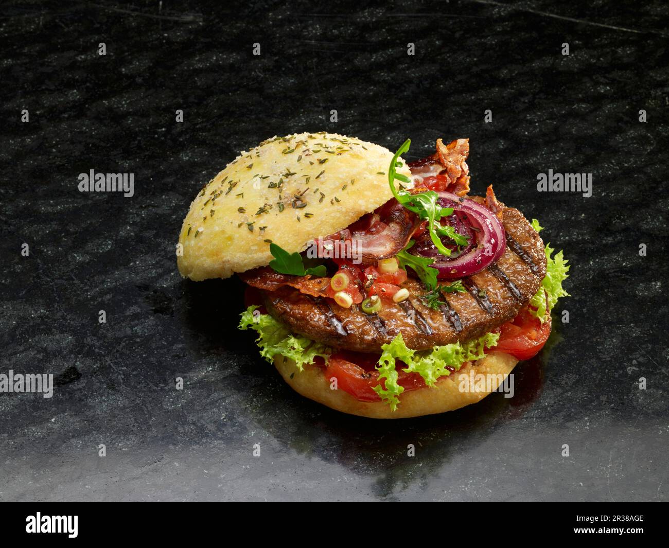 A hamburger on a herb bread roll Stock Photo - Alamy