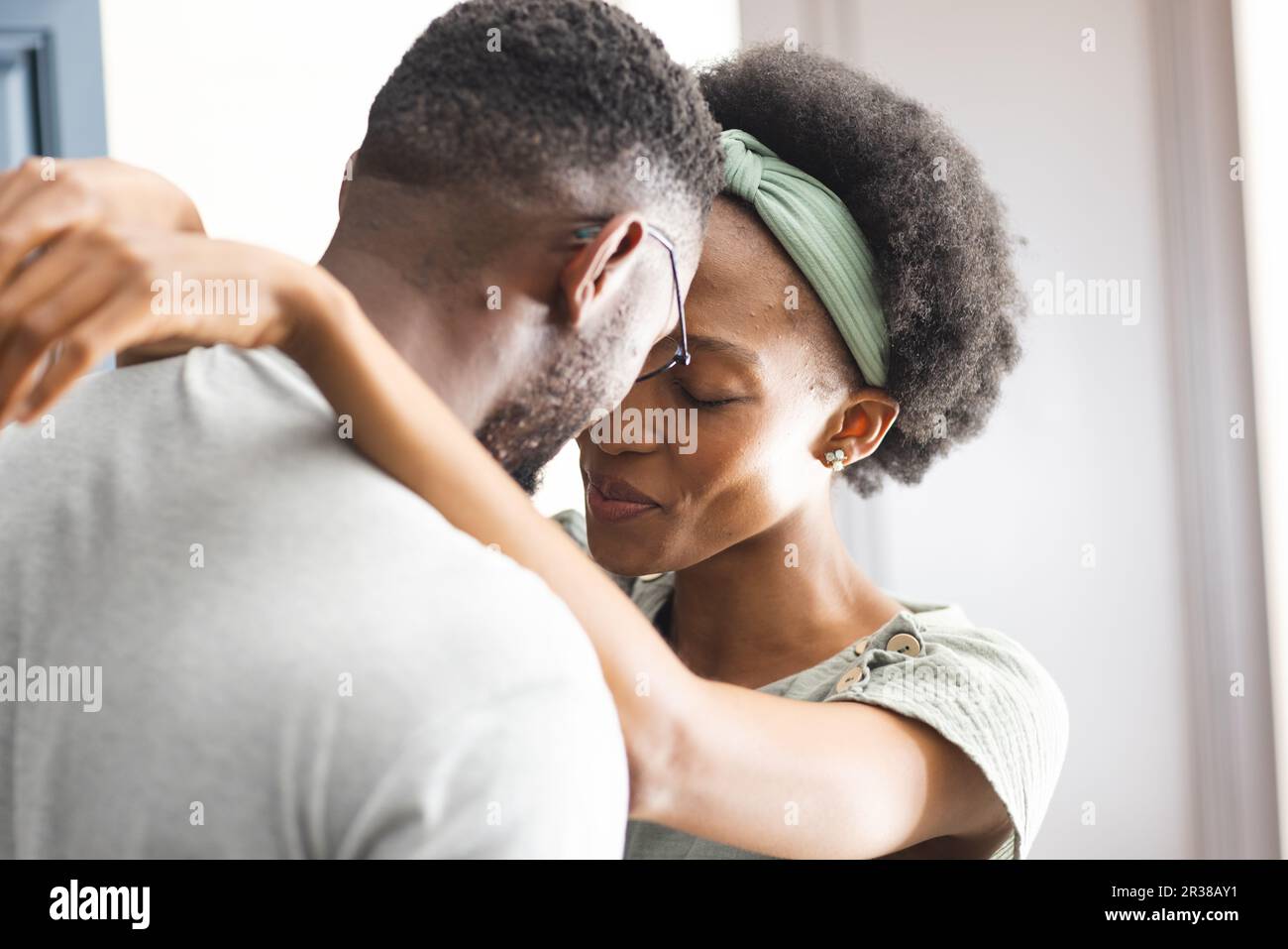 Happy, romantic african american couple touching heads embracing in ...