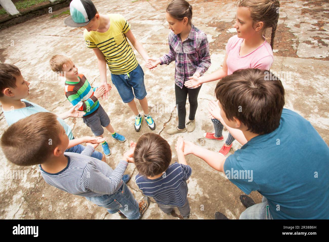 Children playing the game outdoors clapping hands in a circle Stock ...