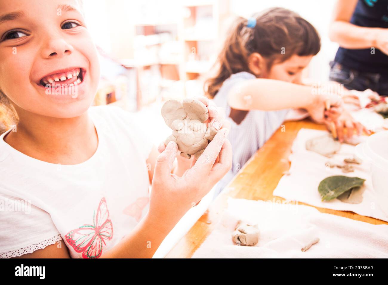 Happy children are engaged with modeling clay Stock Photo - Alamy
