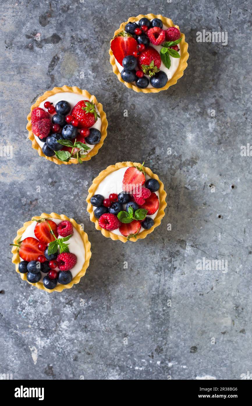 Mixed berry tarts with vanilla cream Stock Photo - Alamy