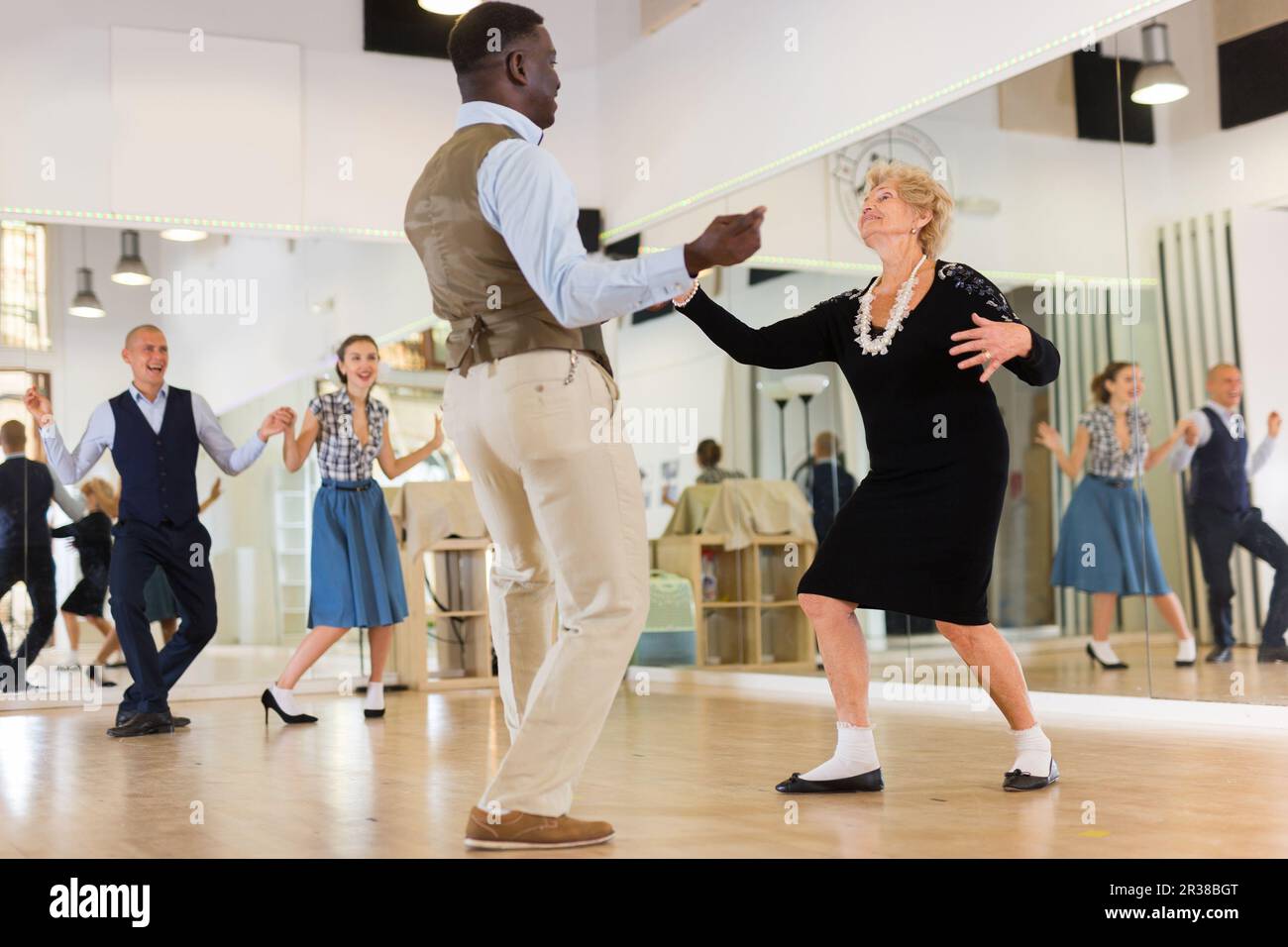 Lady learning to dance lindy hop with man in dance school Stock Photo ...