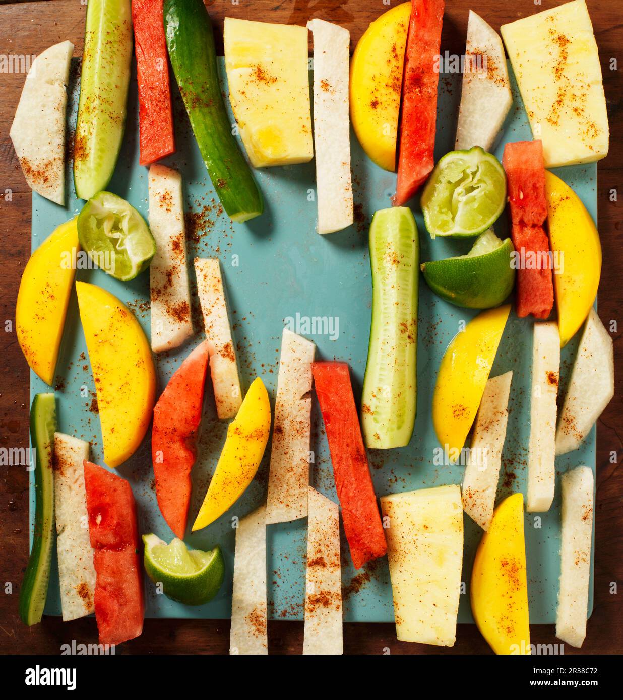 Jicama, vegetables and fruit cut into strips with lines and spices ...