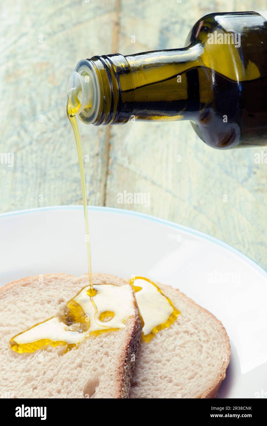 Hands pouring olive oil on hi-res stock photography and images - Alamy