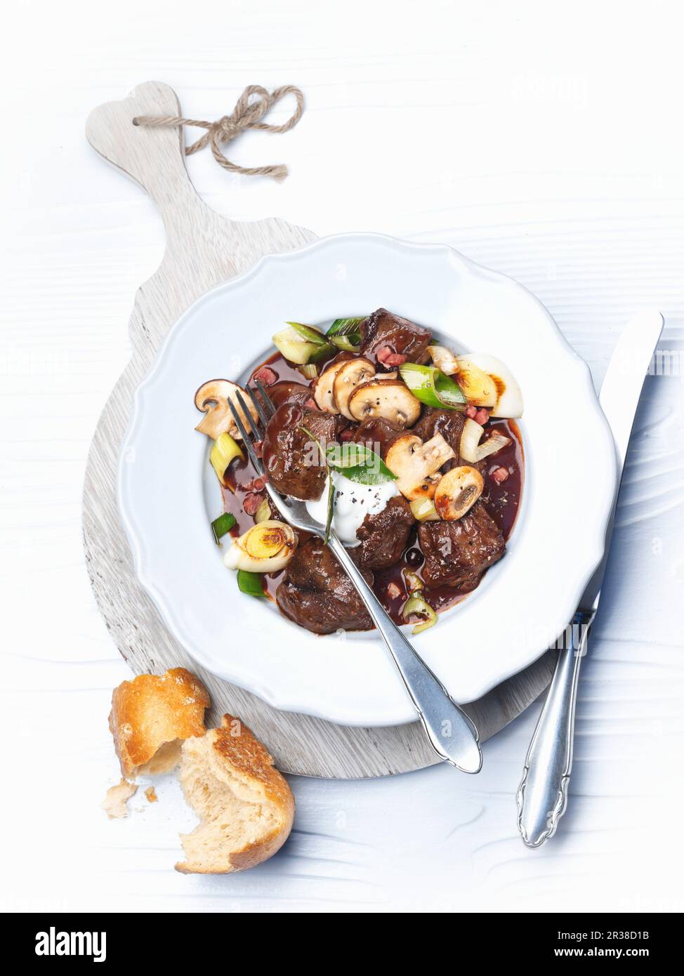 Game stew with mushrooms and leek Stock Photo - Alamy