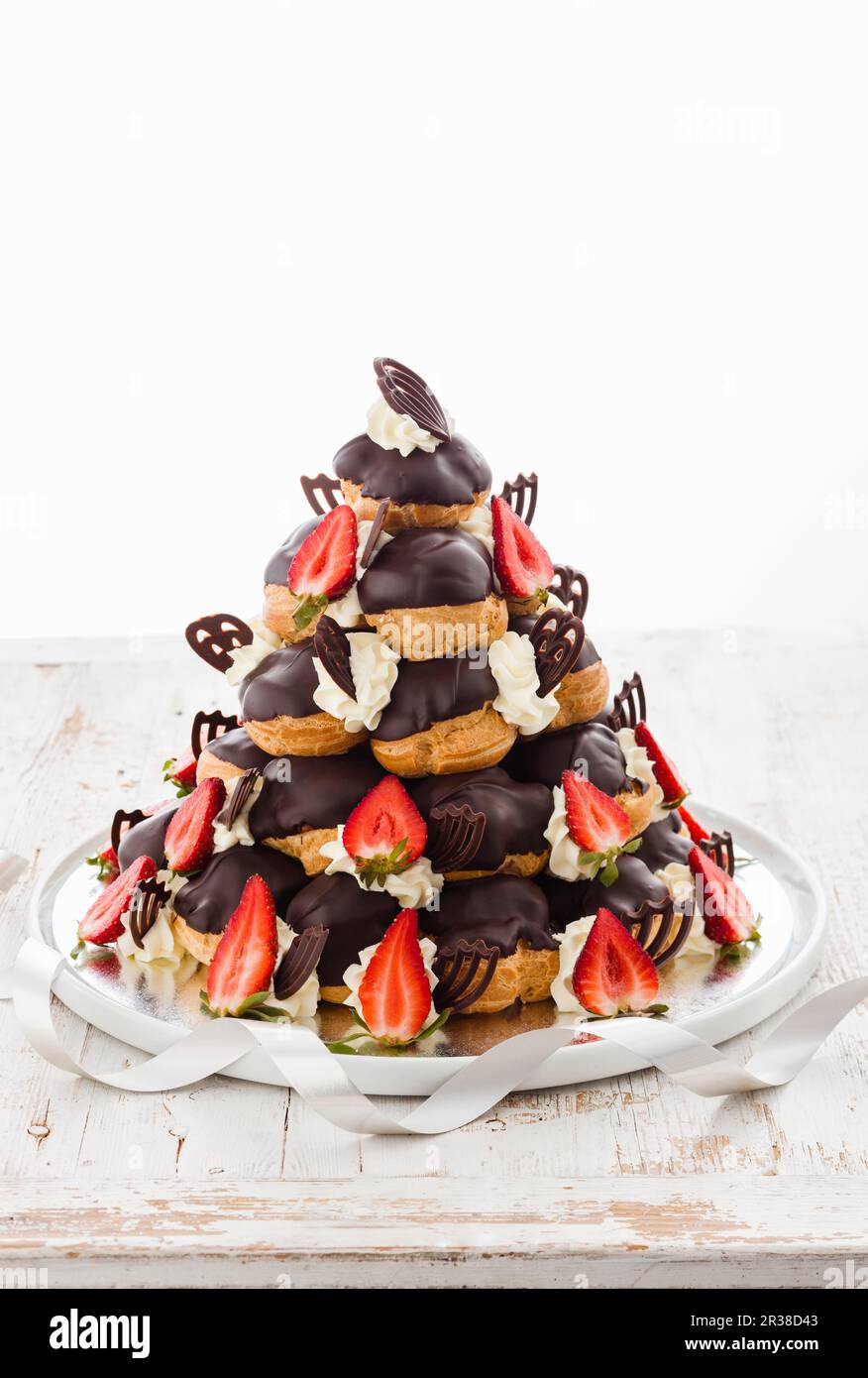 Profiterole pyramid cake with strawberries Stock Photo - Alamy