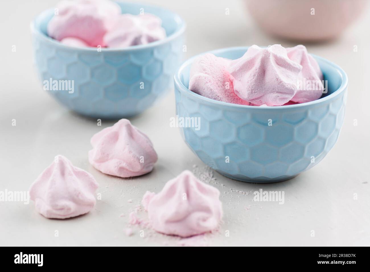 Pink meringue in light blue bowls Stock Photo - Alamy