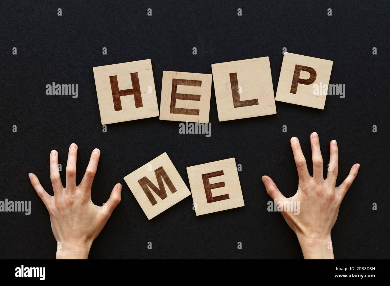 Woman hands and word HELP ME over black Stock Photo - Alamy