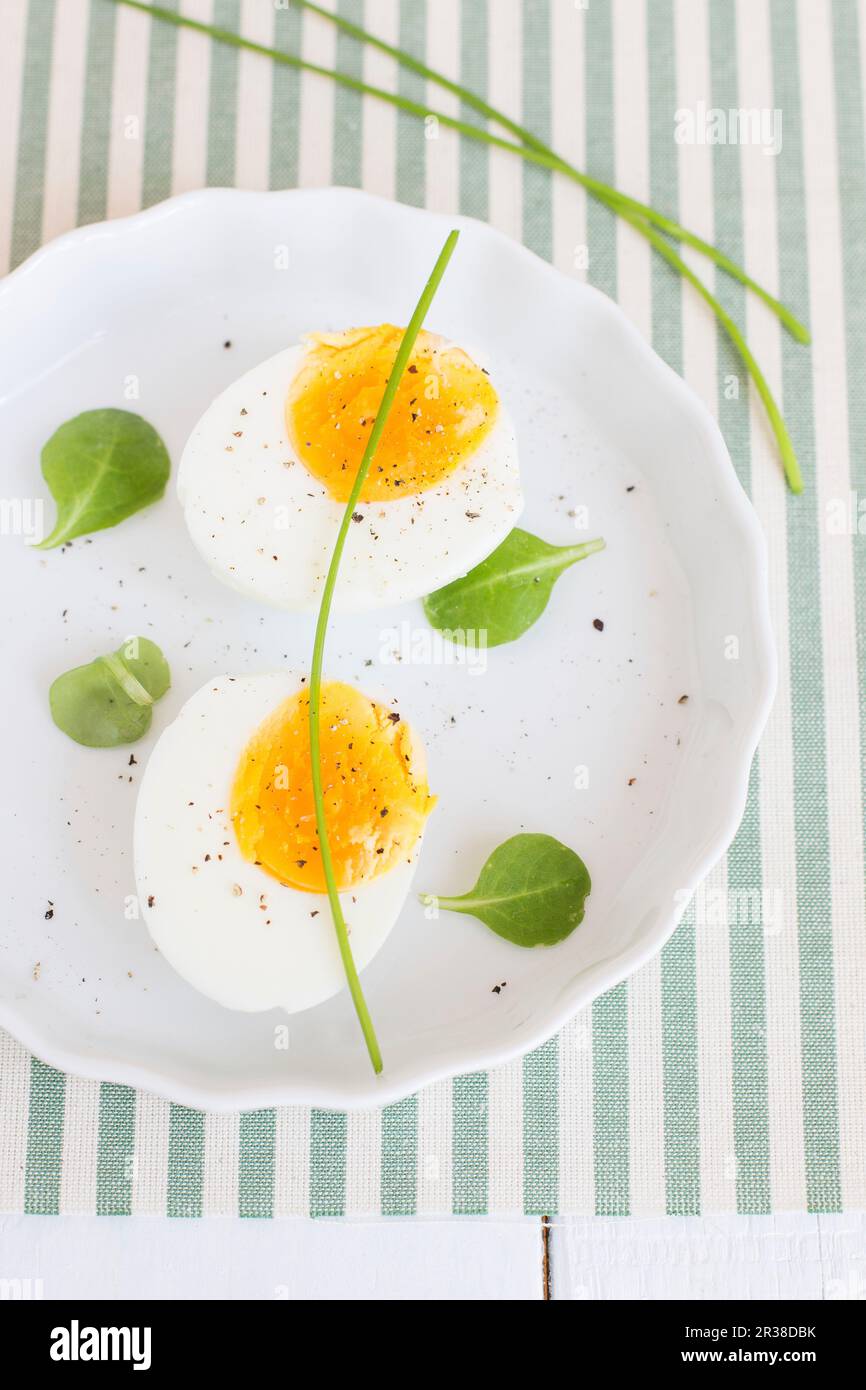 Boiled eggs with pepper and chives Stock Photo - Alamy