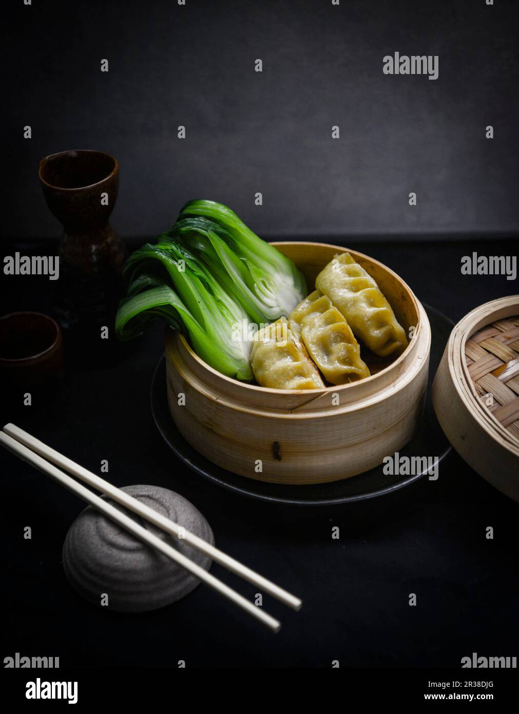 Steamed dumplings with pak choi in a bamboo steamer (Asia Stock Photo ...