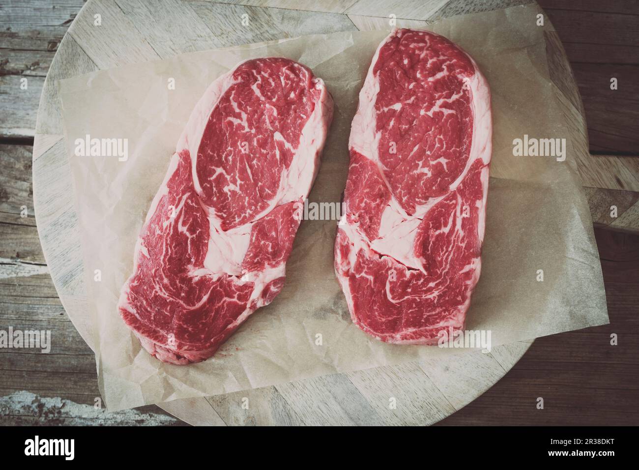 Raw ribeye steaks on a piece of paper Stock Photo - Alamy