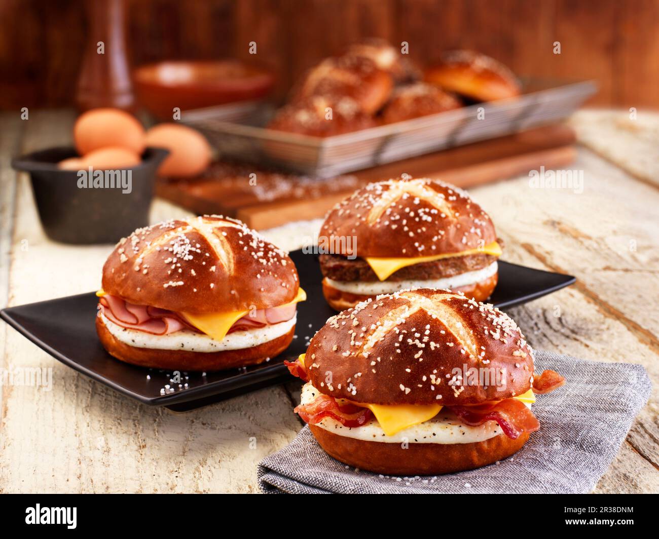 Lye bread rolls with bacon, cheese and fried egg Stock Photo - Alamy