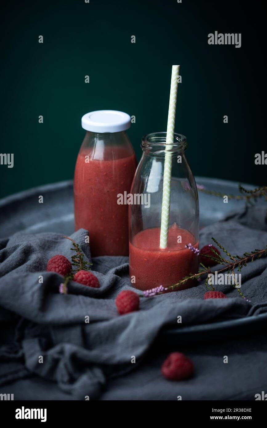 Raspberry smoothies in glass bottles Stock Photo - Alamy