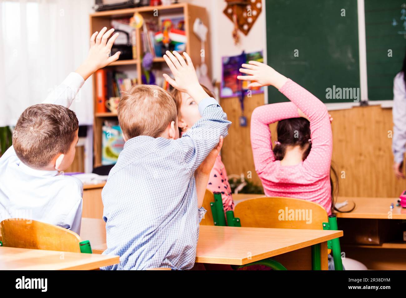 Cute pupils are waiting to answer the question Stock Photo - Alamy