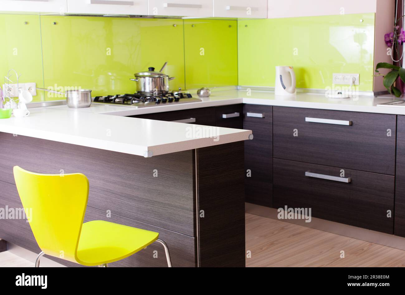 Nice kitchen with great table worktop and yellow chair Stock Photo - Alamy