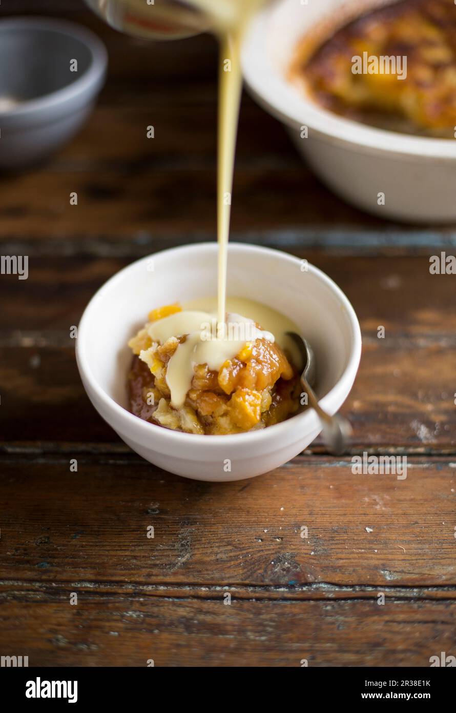 Sticky mango pudding with custard Stock Photo - Alamy