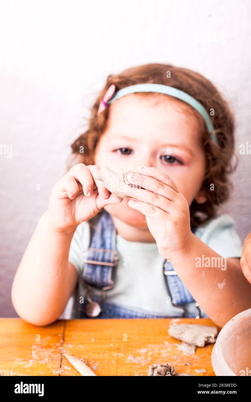 Happy children are engaged with modeling clay Stock Photo - Alamy