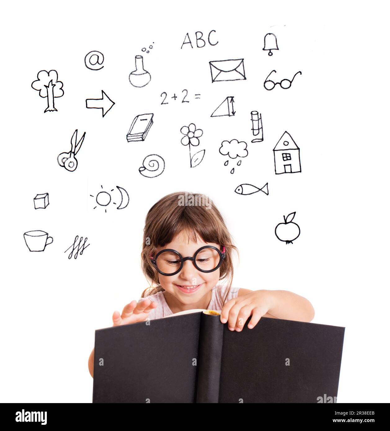 Girl looking at the big book Stock Photo - Alamy