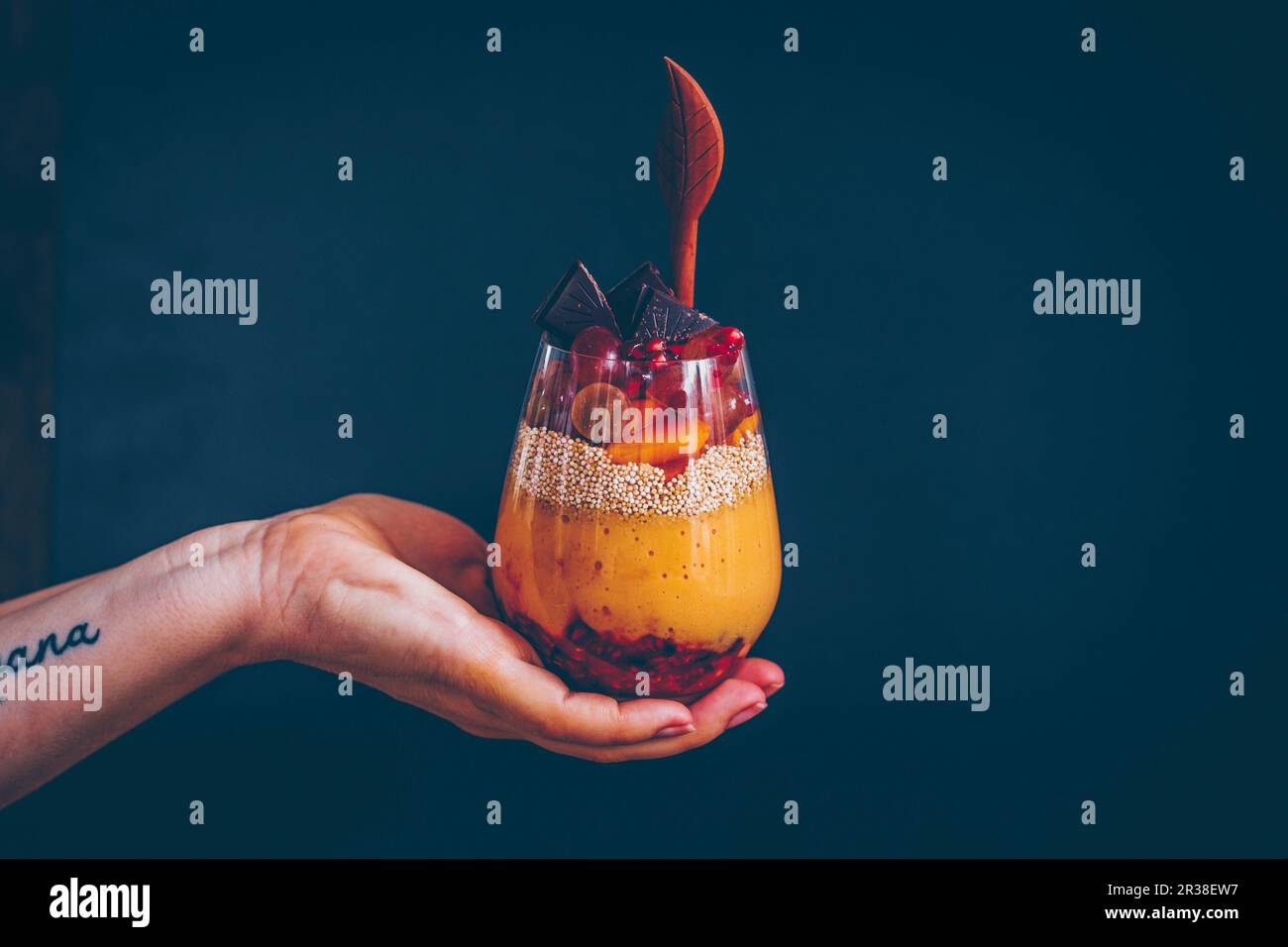 A hand holding a glass of parfait Stock Photo - Alamy