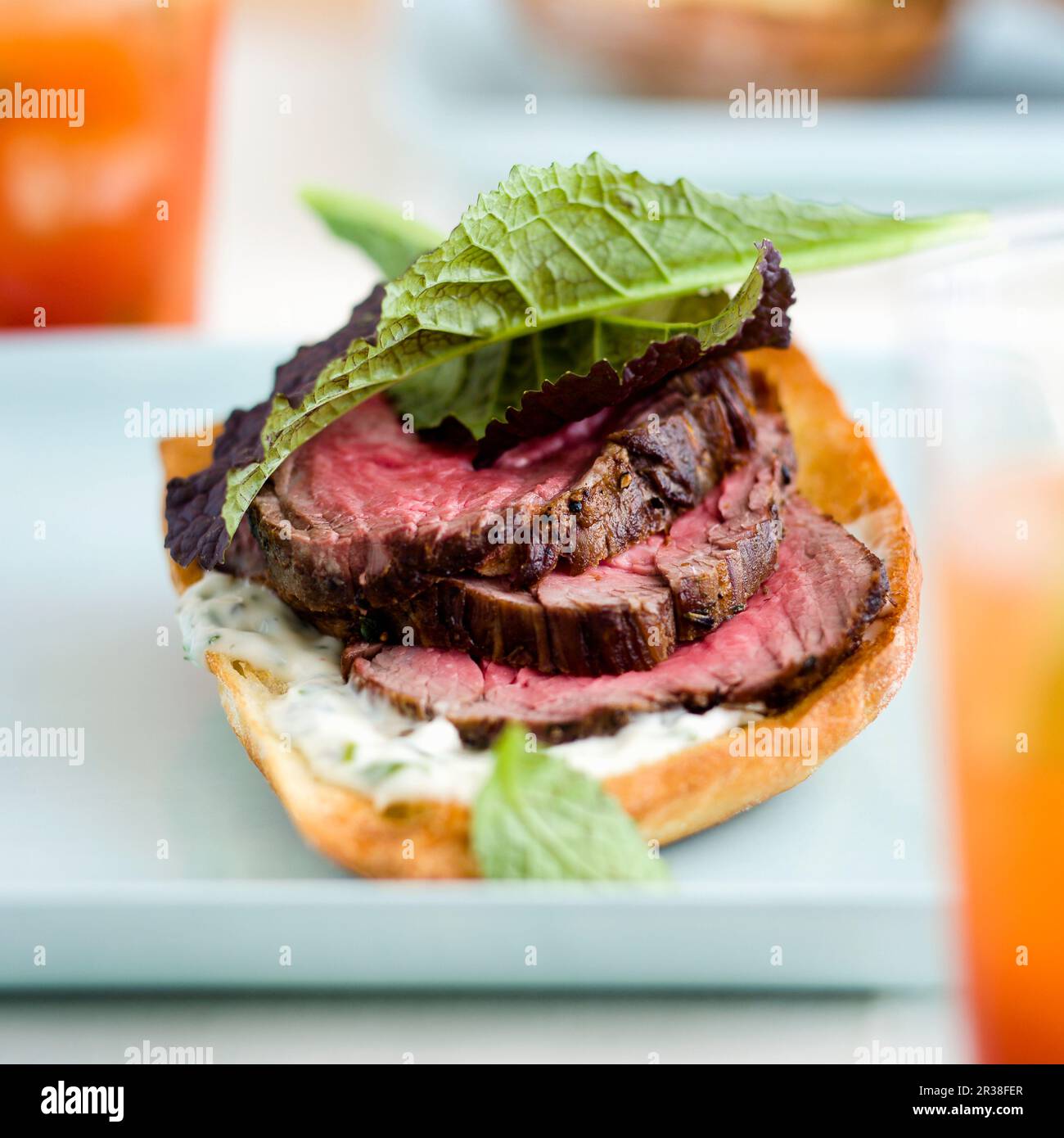 Half a toasted roll topped with beef fillet Stock Photo - Alamy