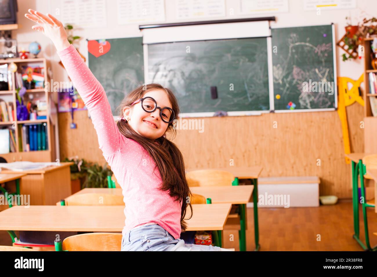 Happy smart girl in classroom Stock Photo - Alamy