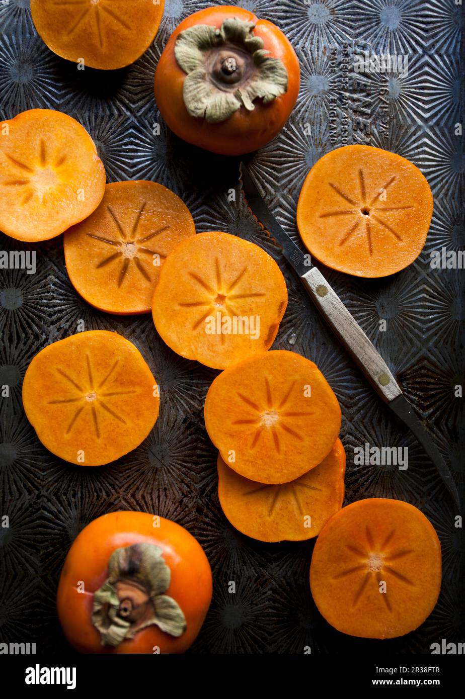 Whole cut fresh persimmons hi-res stock photography and images - Alamy