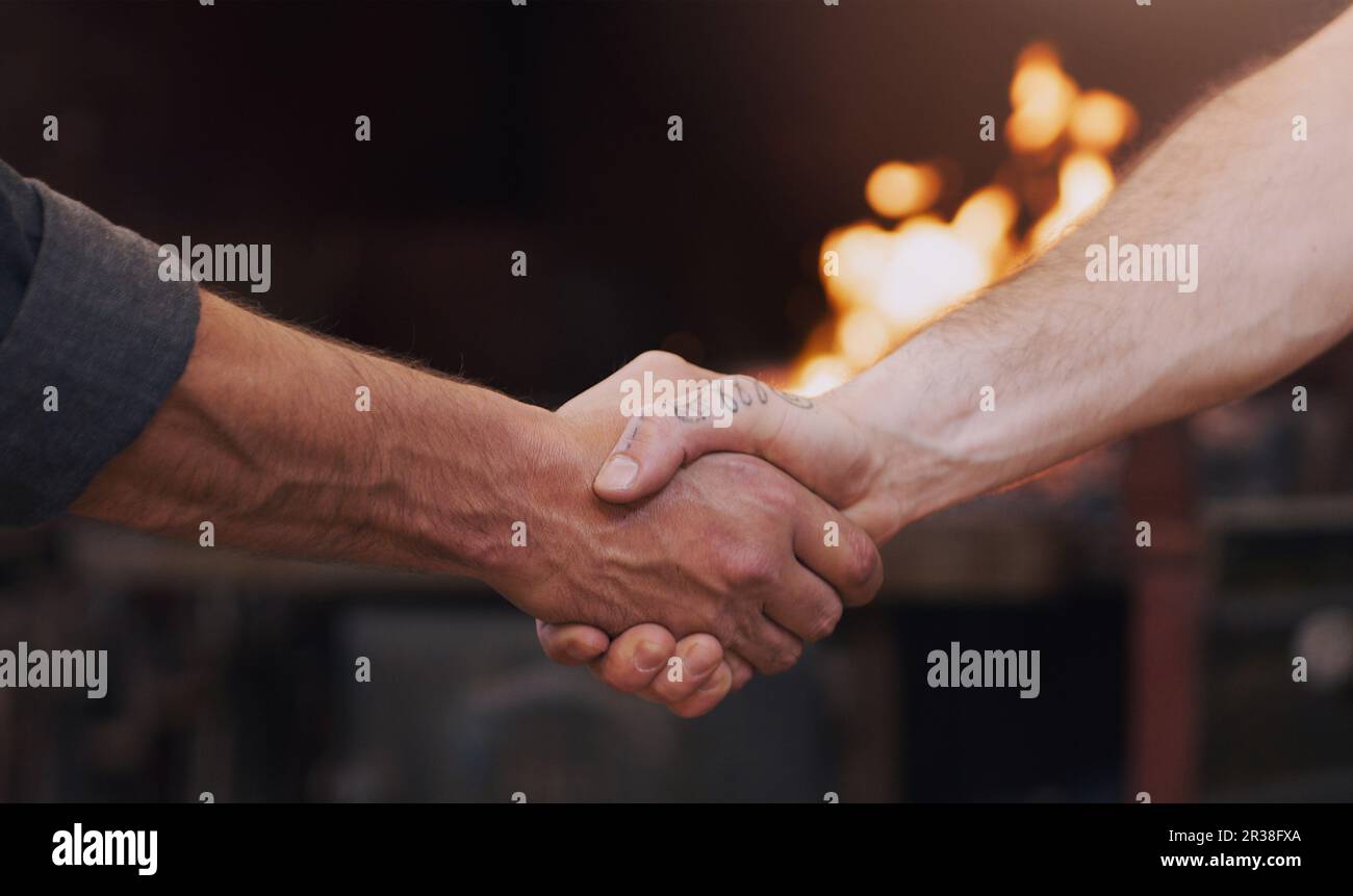 Handshake, meeting and thank you with men in a workshop together for a ...