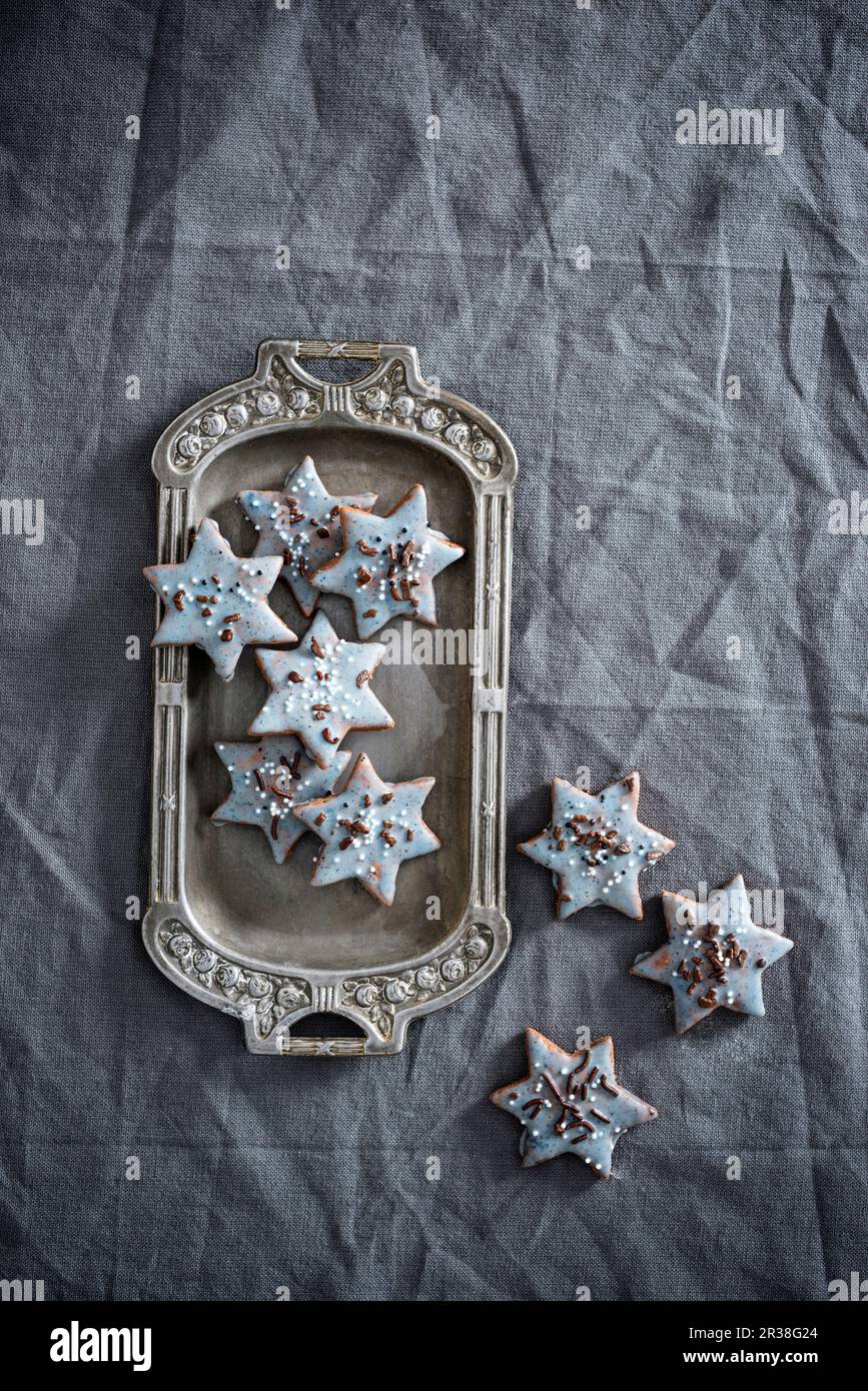 Star-shaped vegan biscuits with pale blue icing and sugar pearls Stock ...