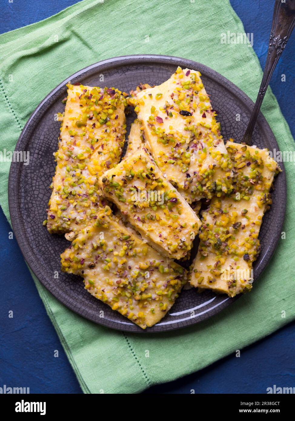 Baked polenta cheese bars topped with pistachio nuts and Parmesan Stock ...