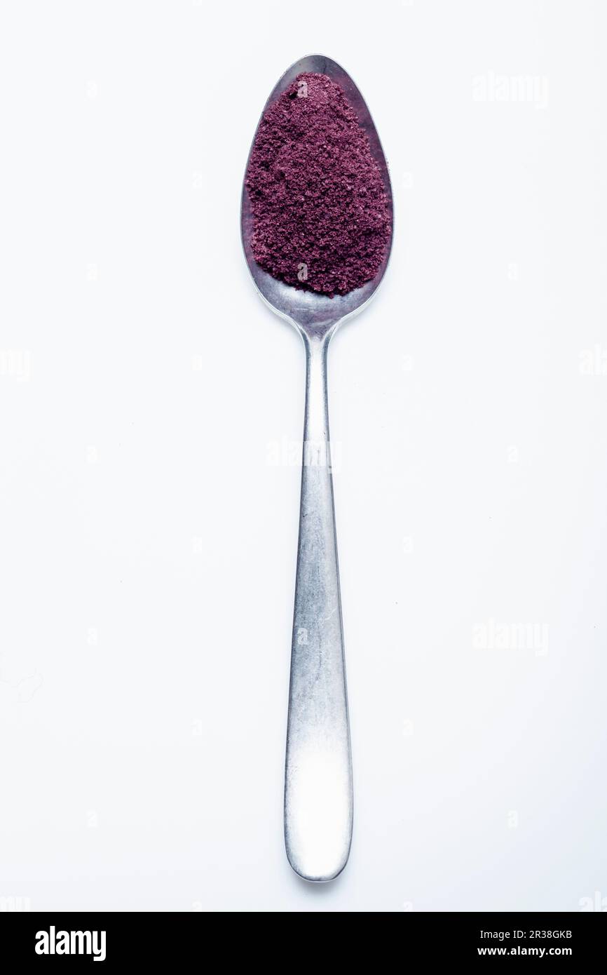 Acai berry powder on a spoon against a white background Stock Photo - Alamy
