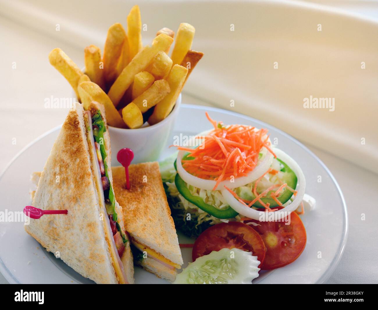 A club sandwich with a side salad and french fries Stock Photo - Alamy