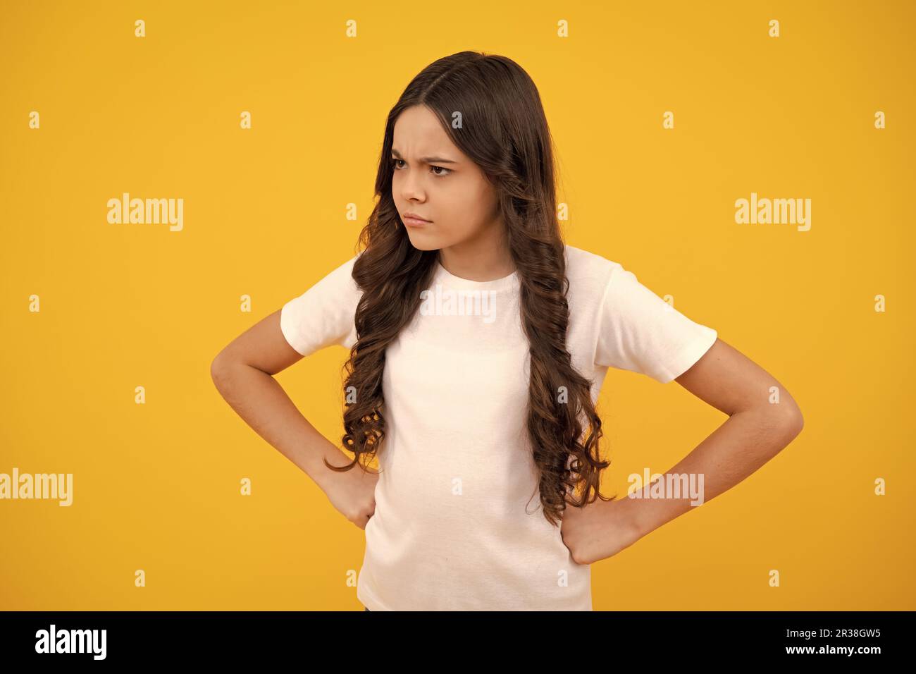 Angry teen girl. Child looking at camera with hate and rage negative facial expression. Unhappy ...