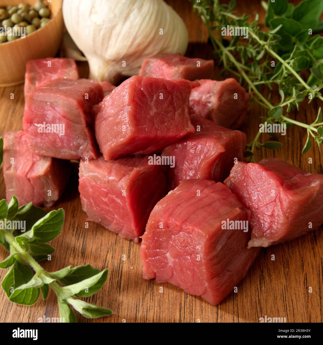 Raw beef cut into cubes with garlic and herbs Stock Photo - Alamy