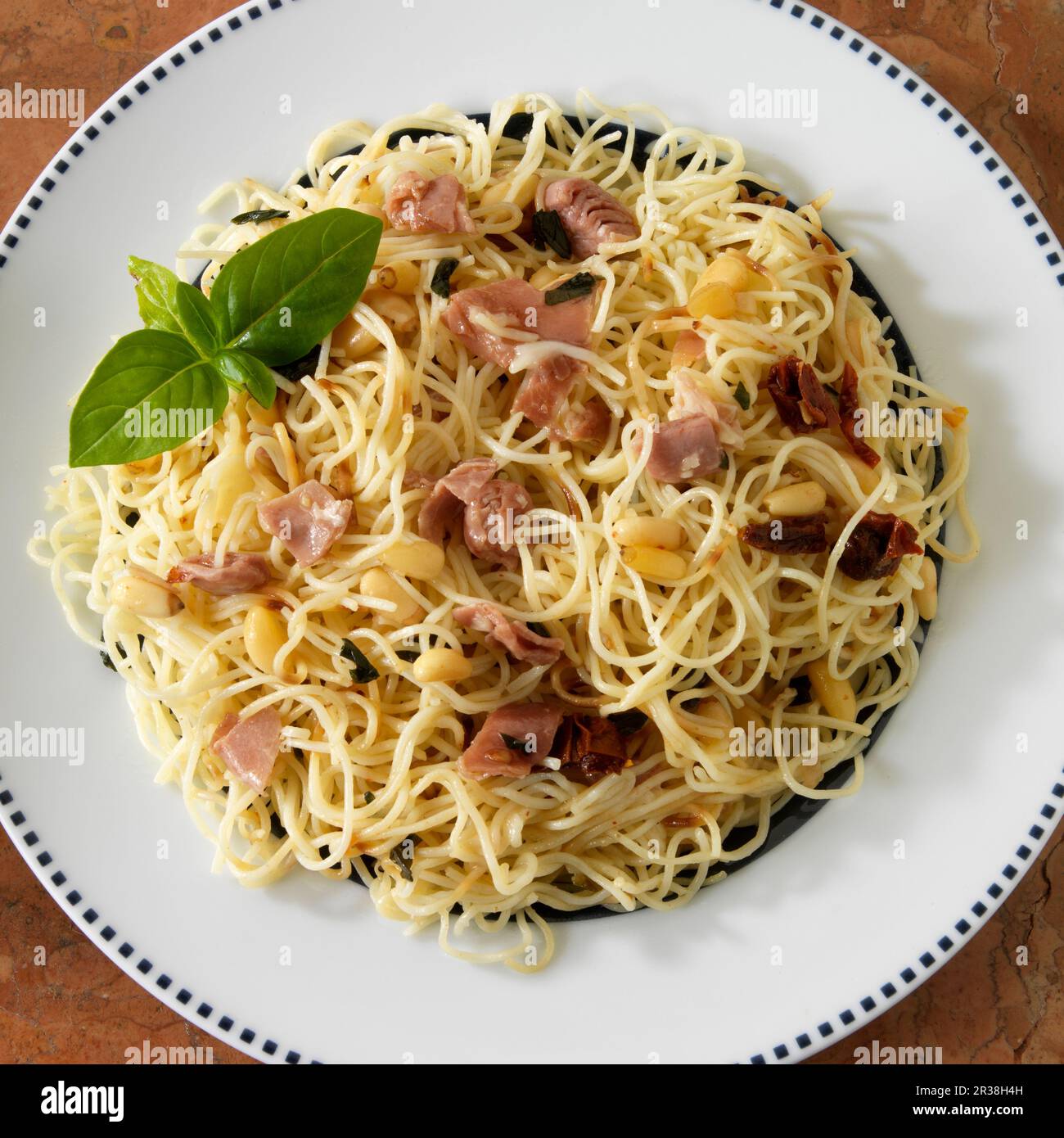 Angel hair pasta with prosciutto, pine nuts, sun dried tomato, basil ...