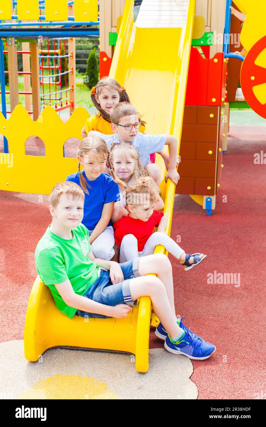 Happy kids playing at the playground Stock Photo - Alamy
