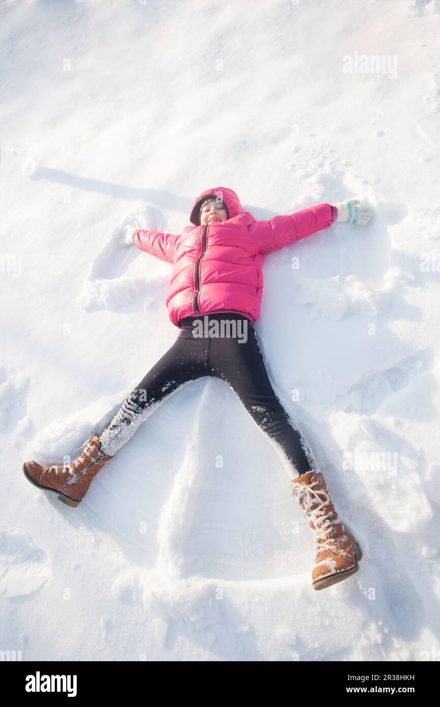Girl makes snow angel Stock Photo - Alamy