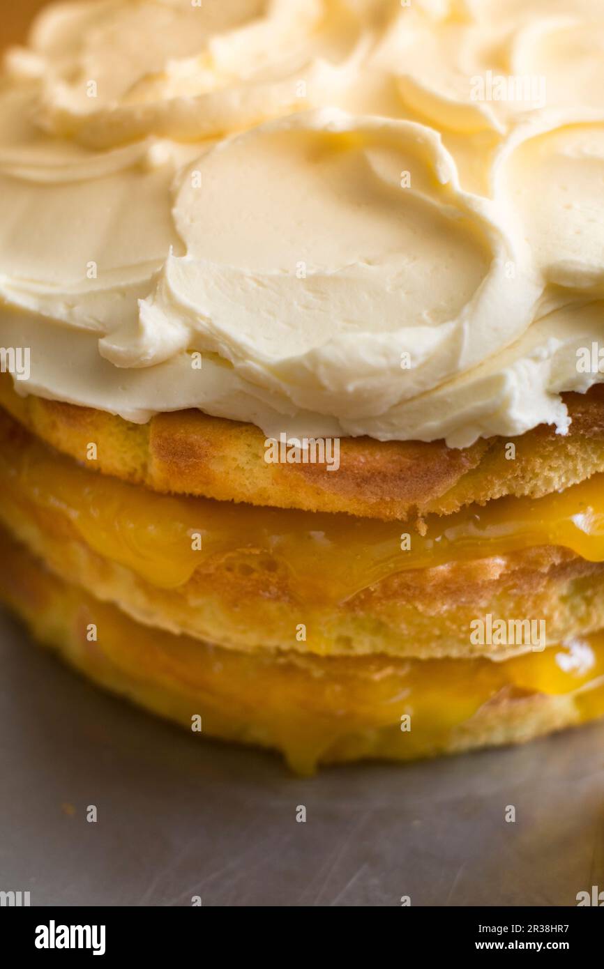 Sponge cake with lemon curd and a cream topping (close-up Stock Photo ...