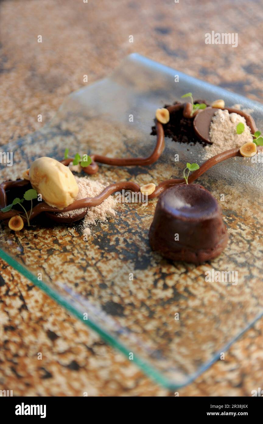 A deconstructed brownie dessert on a glass plate Stock Photo - Alamy