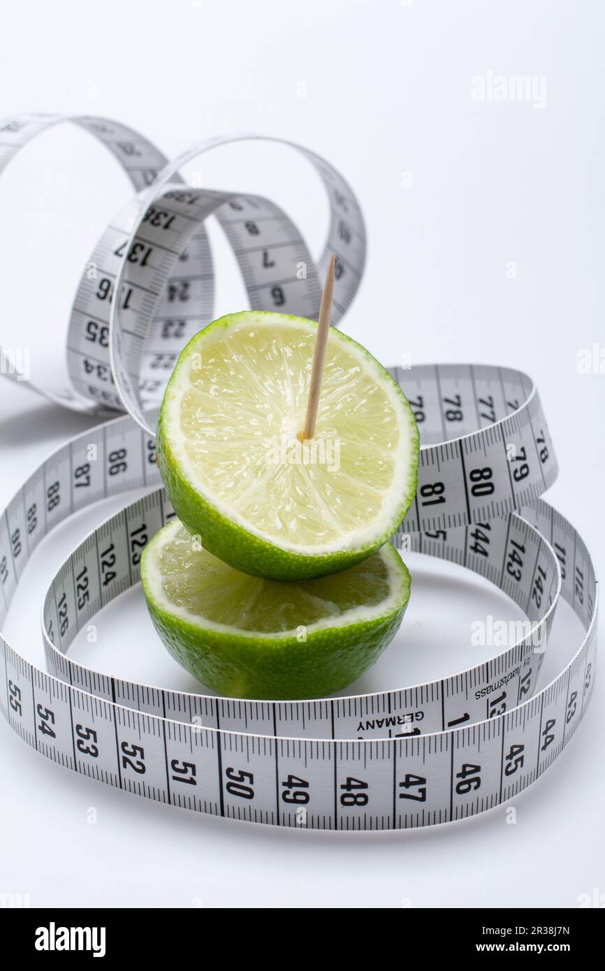 Lime halves with a toothpick and a measuring tape Stock Photo - Alamy