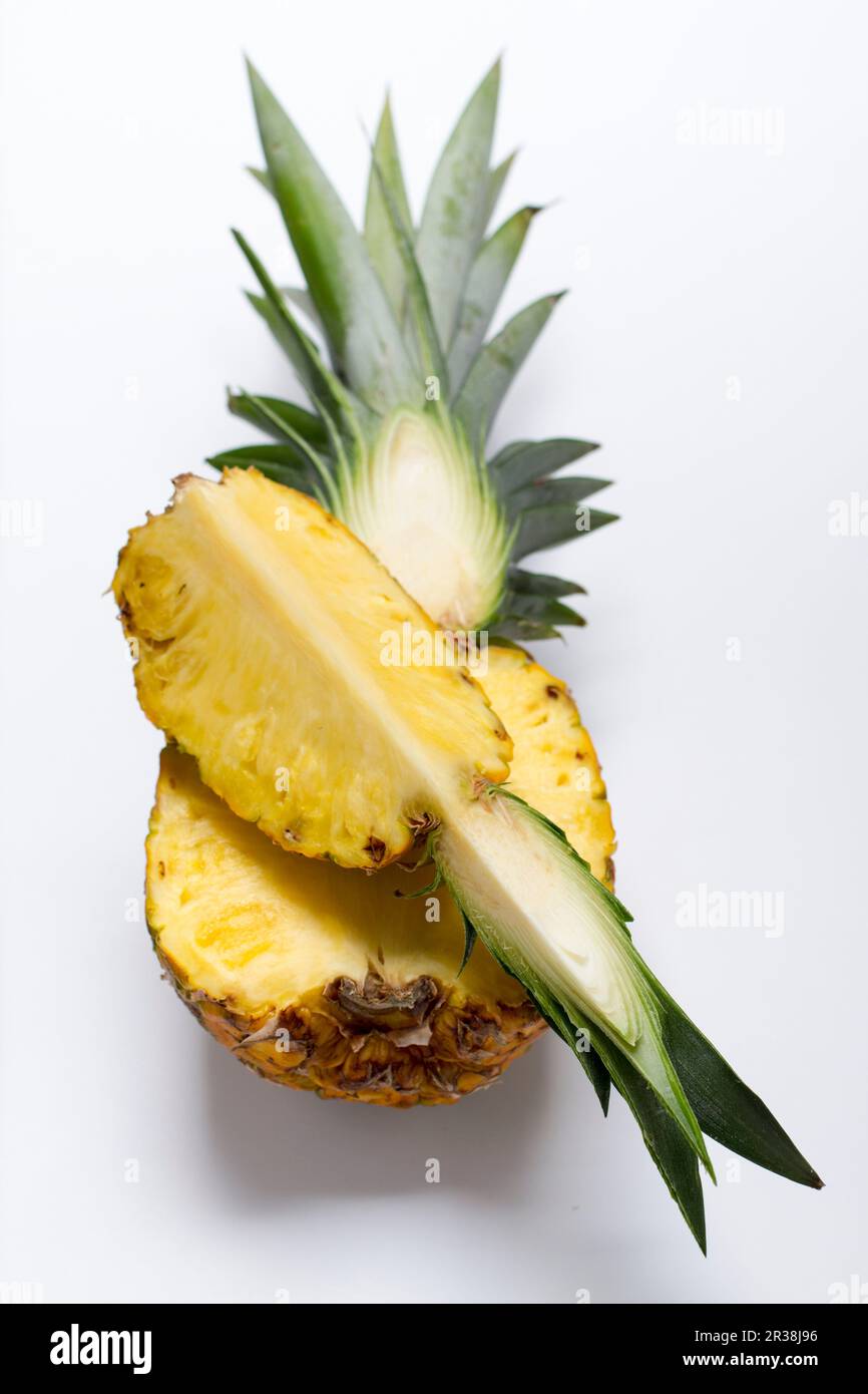 A half and a quarter slice of pinapple against a white background Stock ...