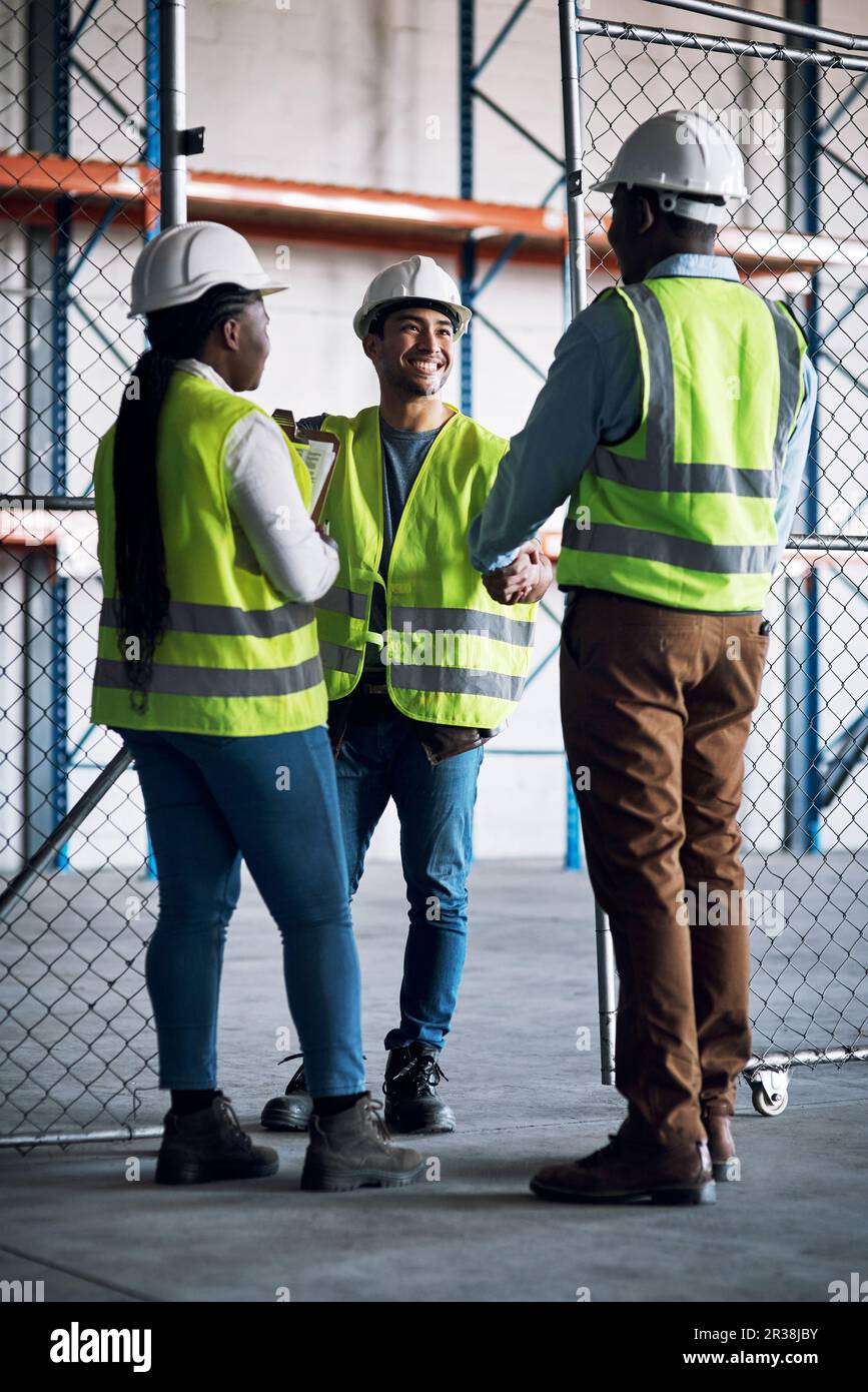 Builder, team and handshake at a construction site for a collaboration ...