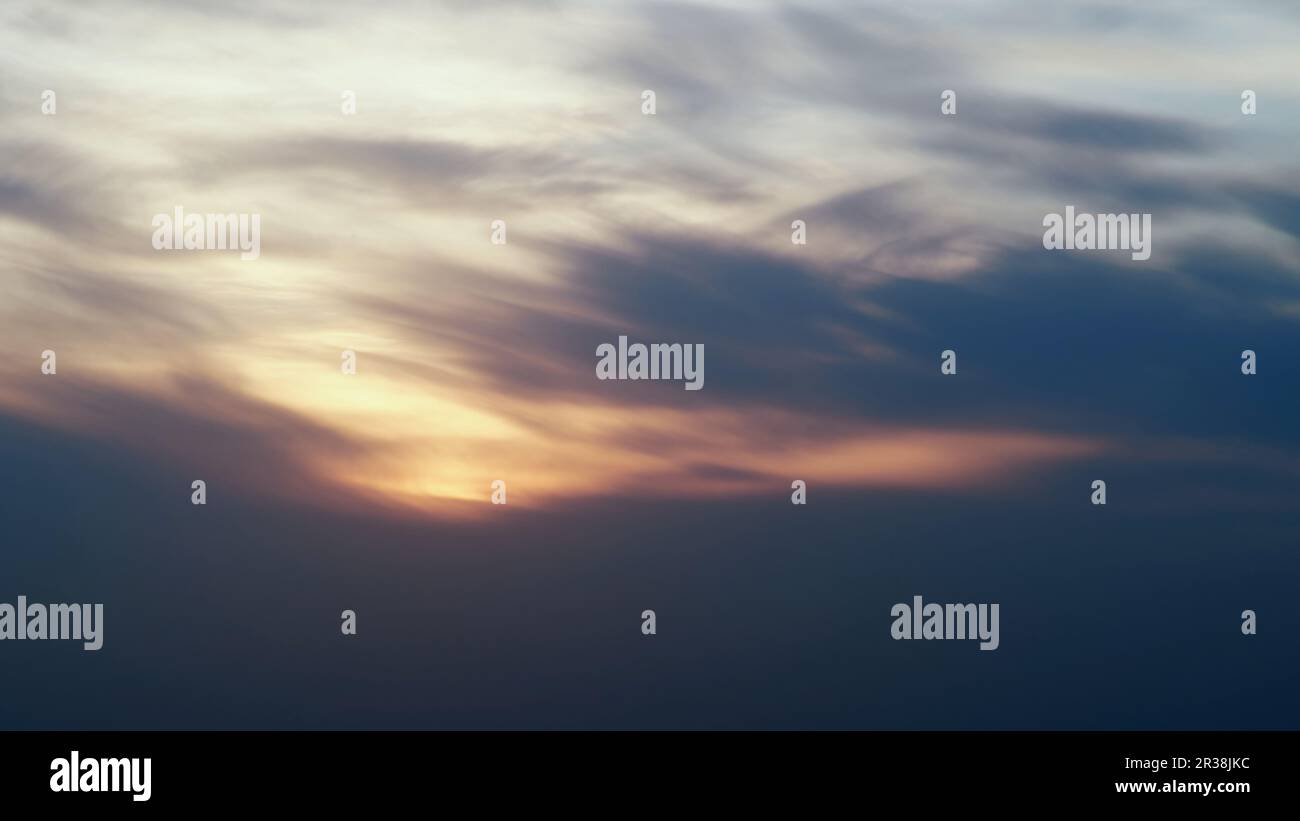 Sunset sky with red light of the setting sun. Evening clouds in the ...