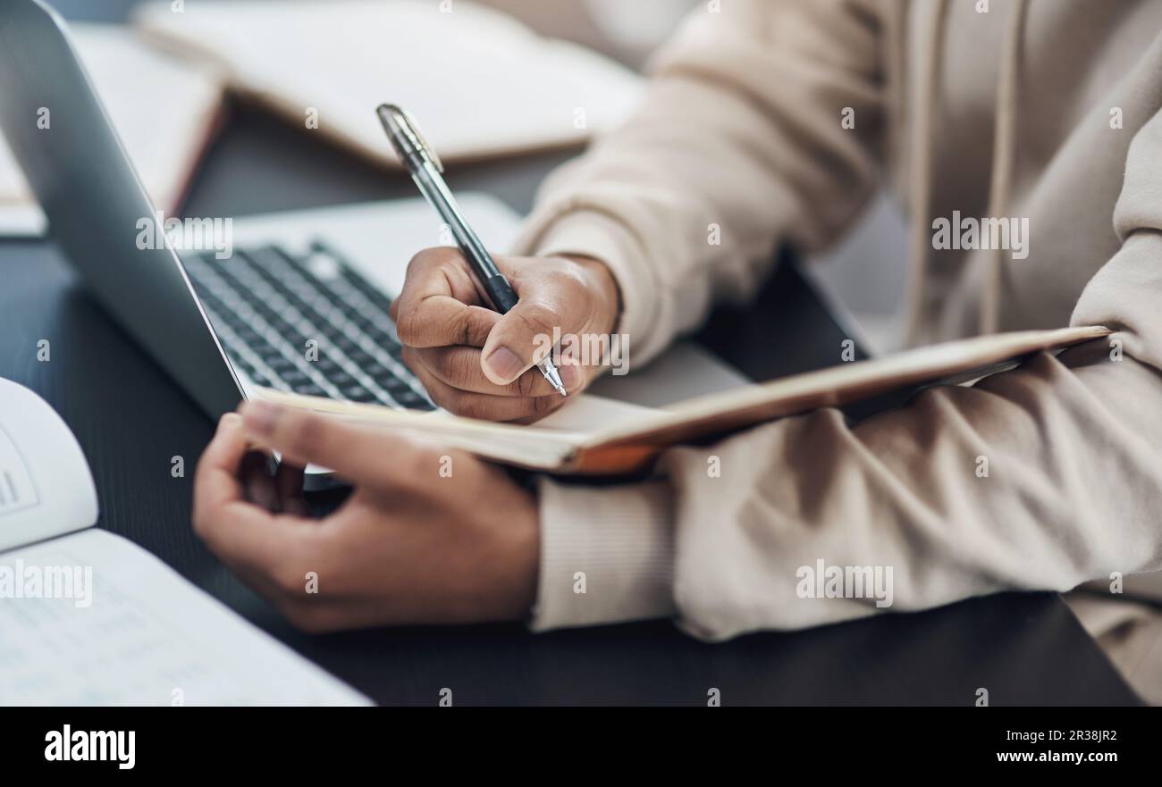 Closeup, hands and man writing in a notebook, remote work from home and ...