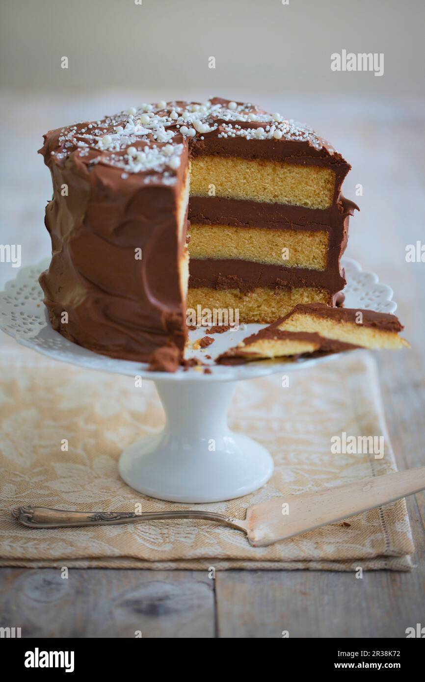 A three-layer chocolate cream cake, sliced Stock Photo - Alamy
