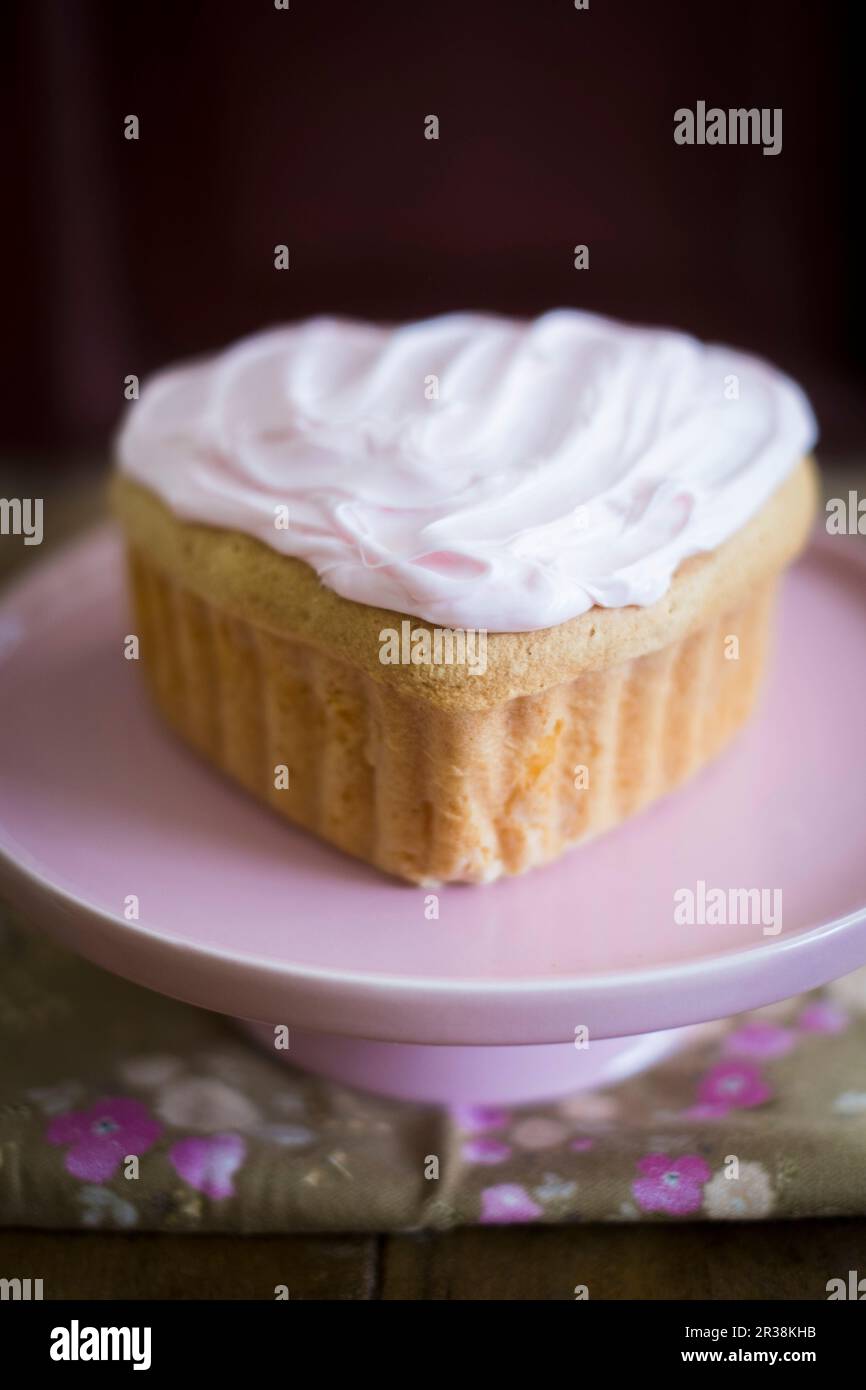A mini heart-shaped cake with frosting Stock Photo - Alamy