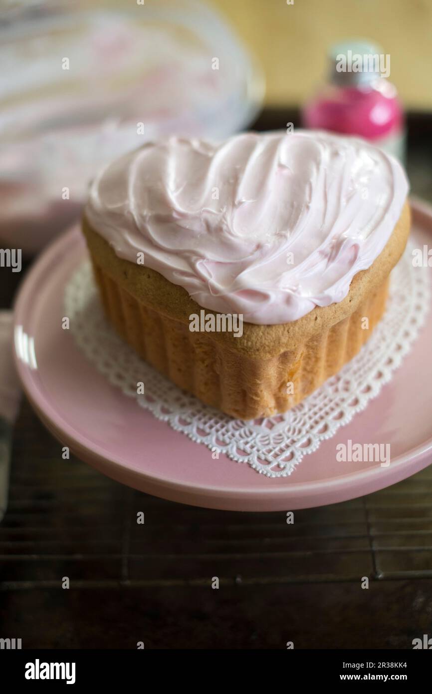 A mini heart-shaped cake with frosting Stock Photo - Alamy